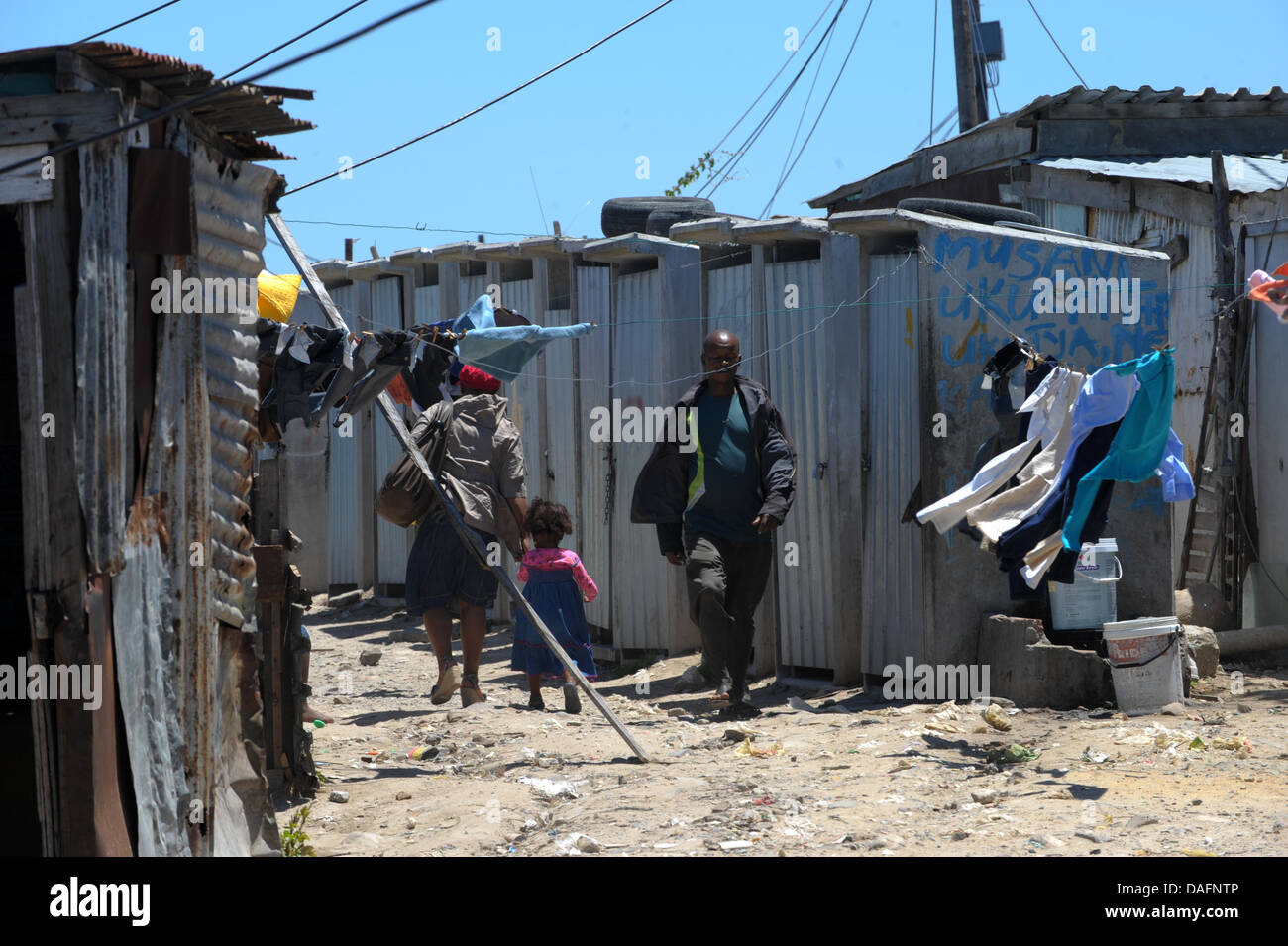 Pedestrians walk past a public toilet in Philippi township near Cape ...