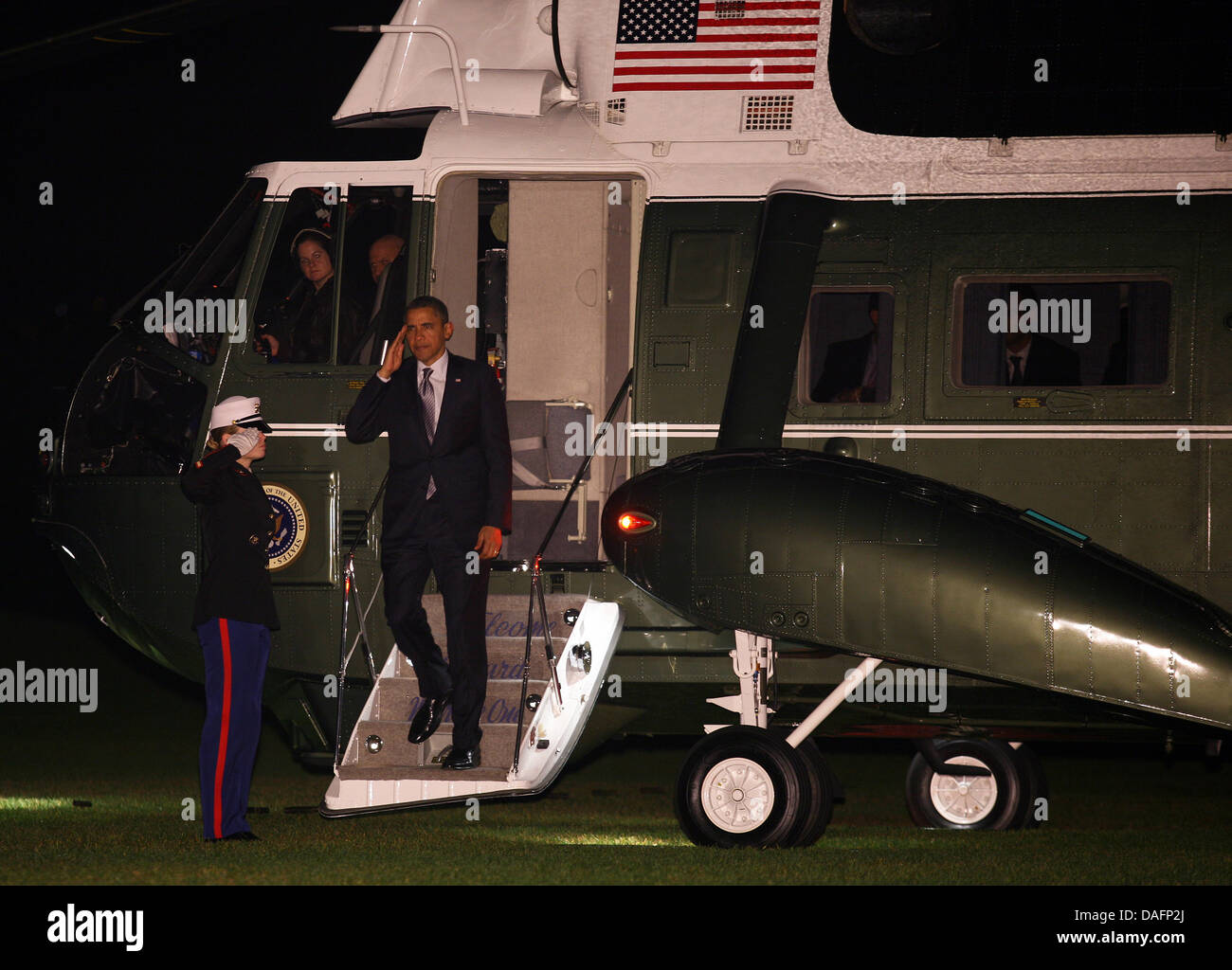 United States President Barack Obama salutes the Marine Guard as he ...
