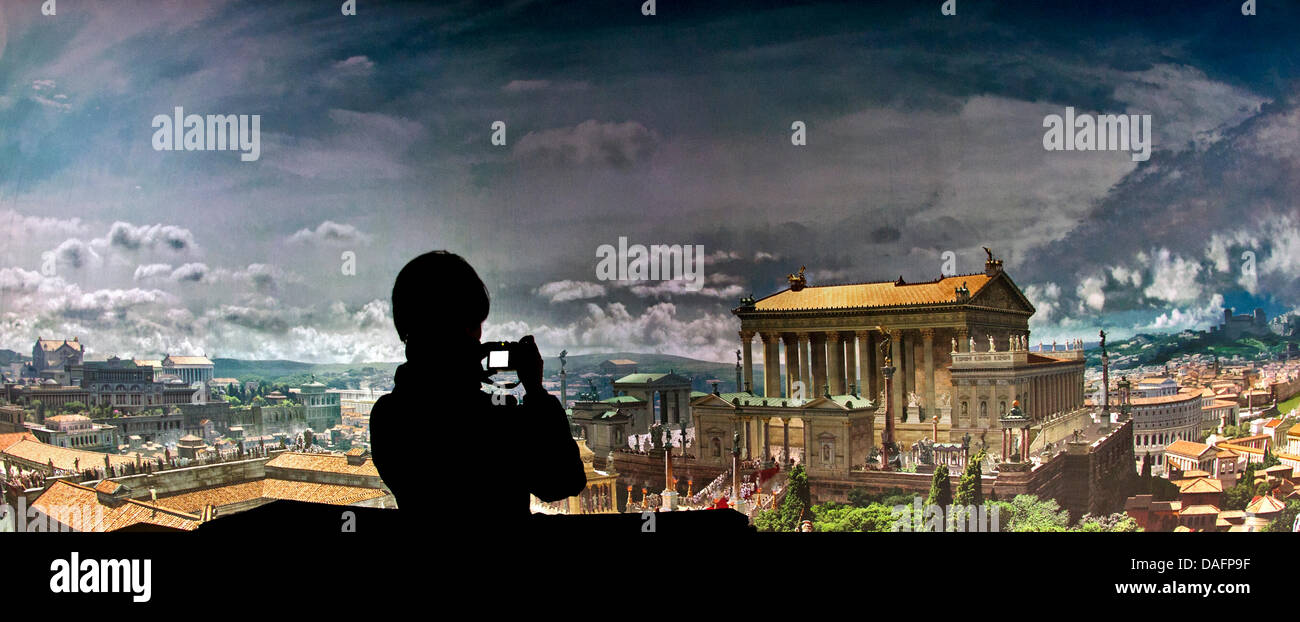 A visitor takes a picture of a 360-degree-panorama picture of ancient ...