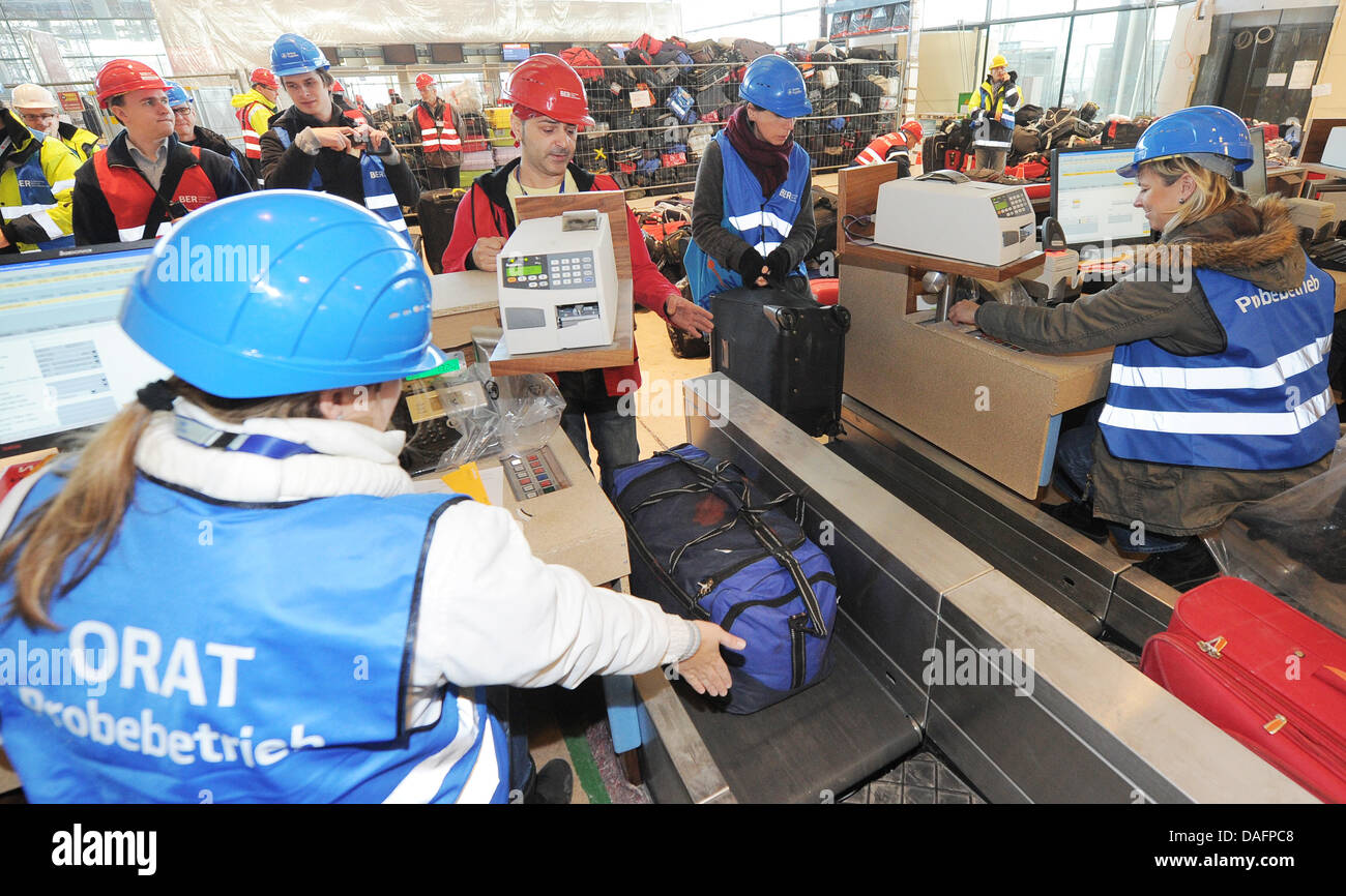 Lufthansa employees rehearse a check-in during a test-run at the future ...