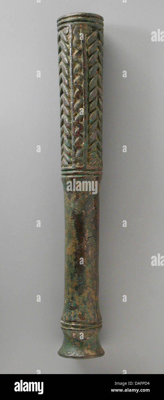 This handle or socket, made from bronze, is intricately designed and ...