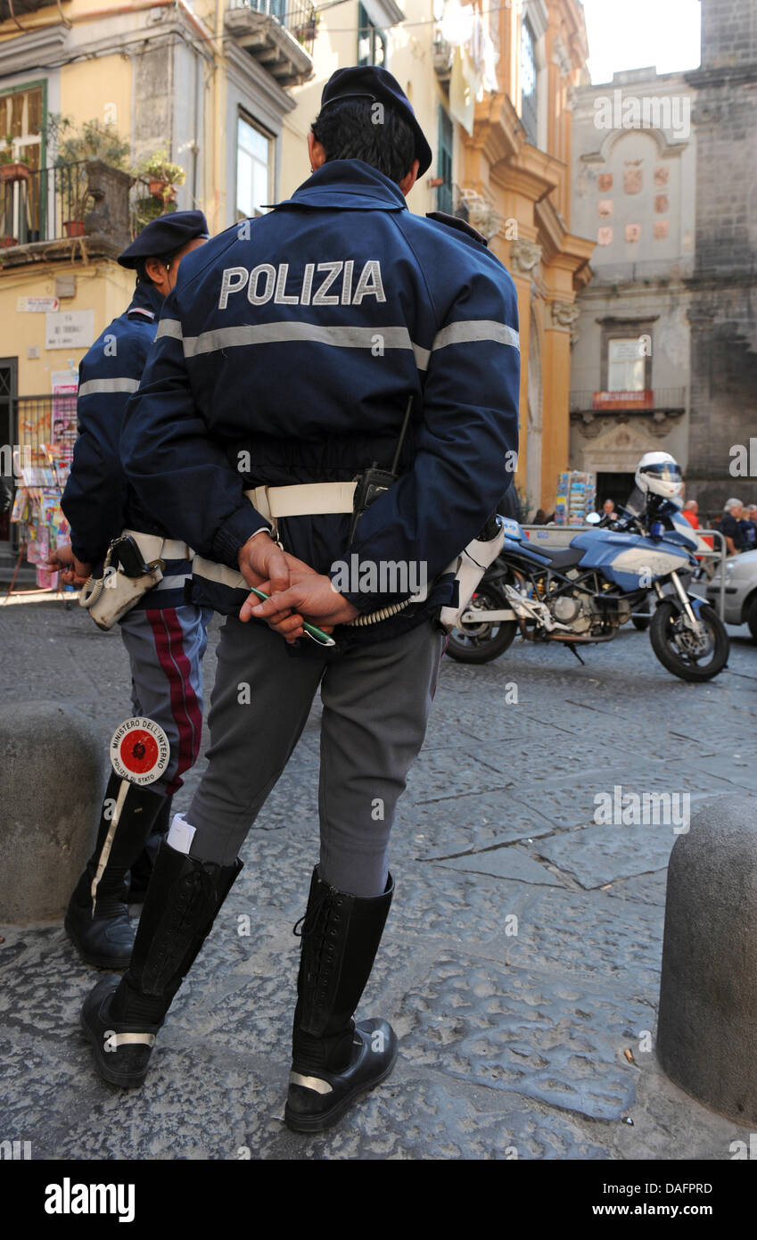 Police officers patrol through the narrow streets and alleyways in ...