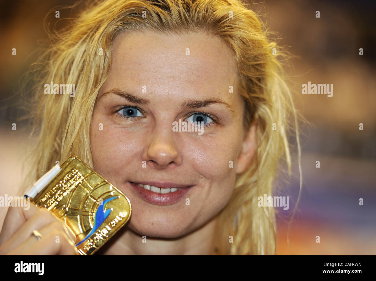 Britta Steffen of Germany displays her gold medal after winning the 50m ...
