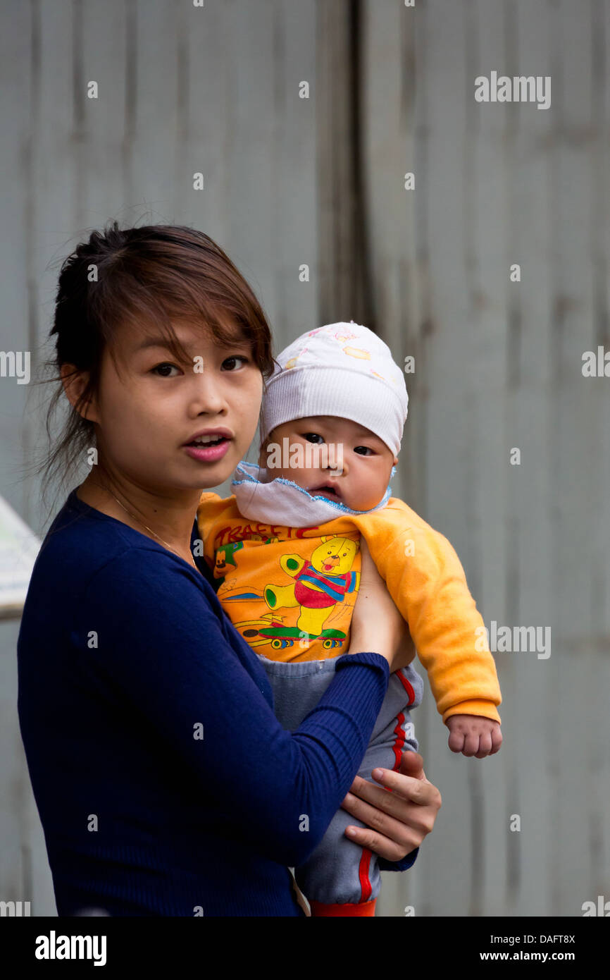 Vietnamese Woman with Baby in the Streets of the Old Quarter in Hanoi ...