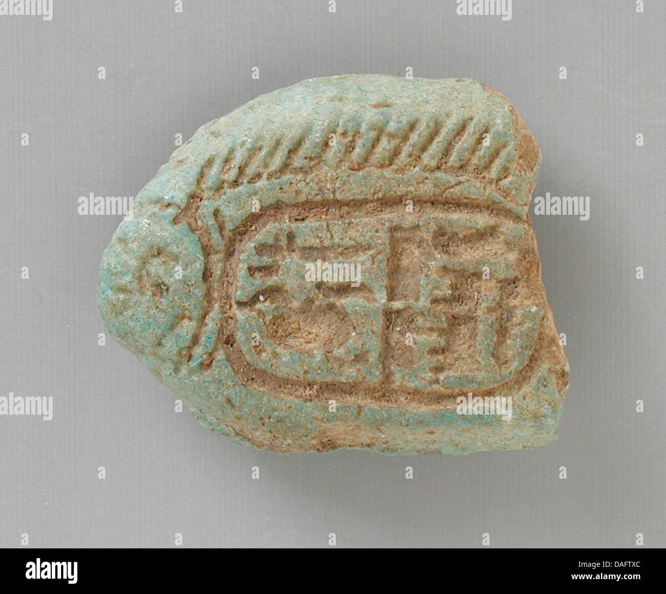 This faience plaque in the shape of a fish features the throne name of ...