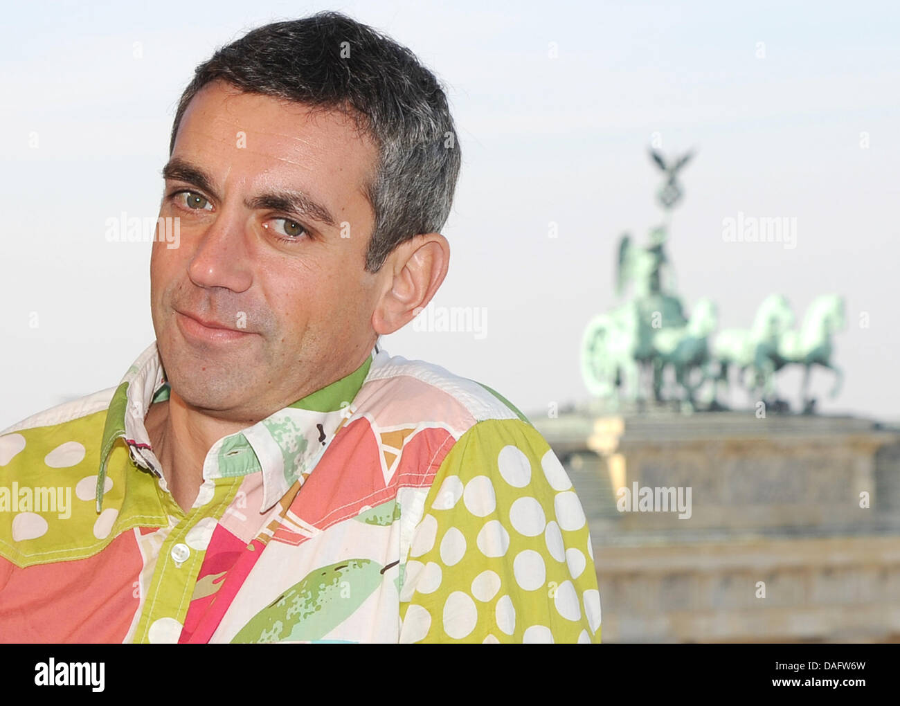 Author Wladimir Kaminer poses in front of Brandenburg Gate in Berlin ...