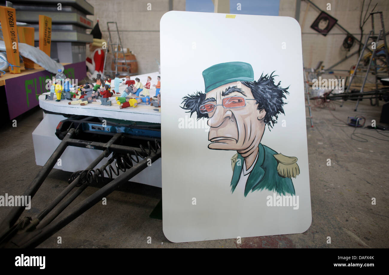 A drawing of Gaddafi is part of a house of cards for a waggon of the ...