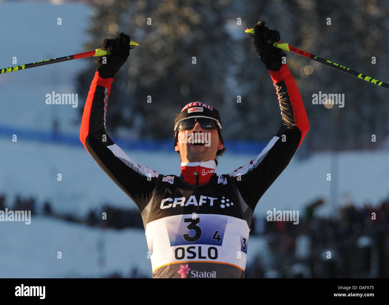 Winner Mario Stecher of Austria celebrates while crossing the finish ...