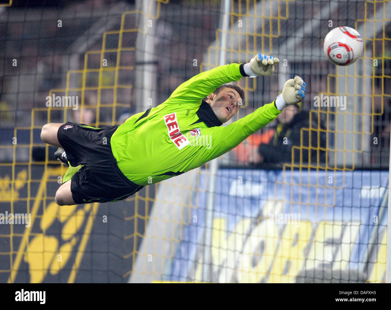 Cologne's goalkeeper Michael Rensing dives for a ball during the ...