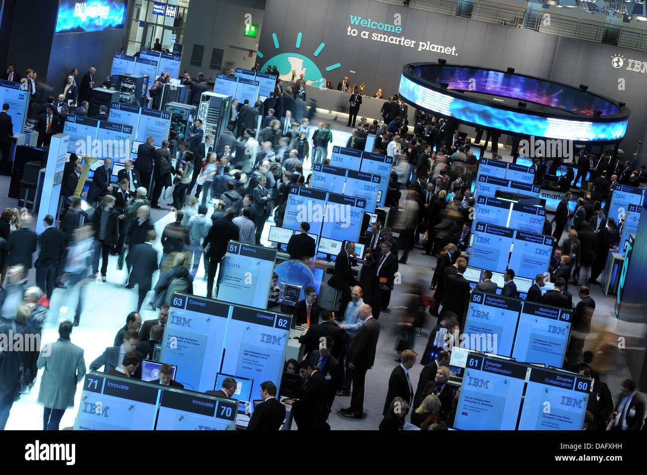Visitors mingle at the IBM stall at CeBIT information technology expo ...