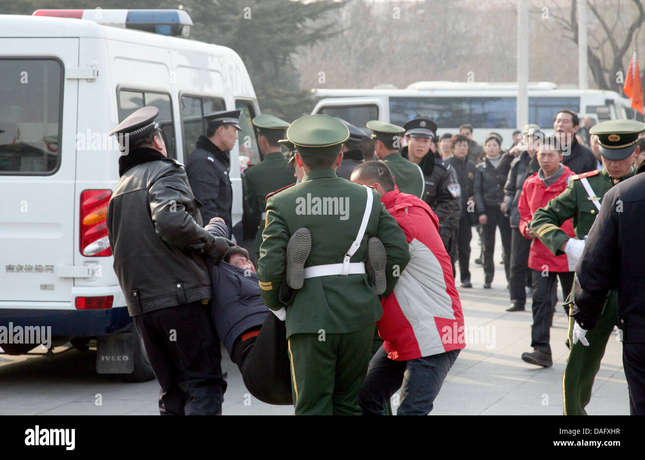 Policemen carry off a protester at Tiananmen Square in Beijing, China ...