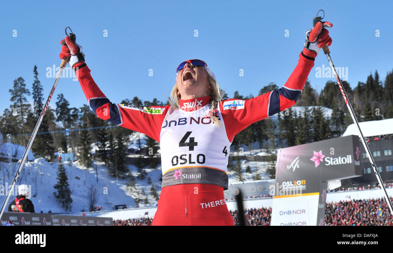 Winner Therese Johaug of Norway raises her arms in joy as she crosses ...