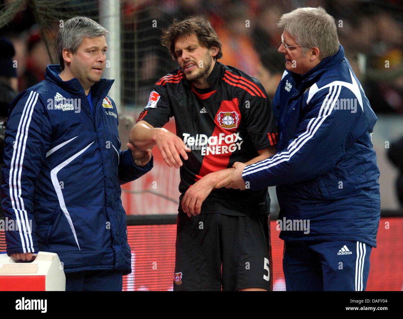 Leverkusen's Manuel Friedrich is taken from the pitch, due to an injury ...