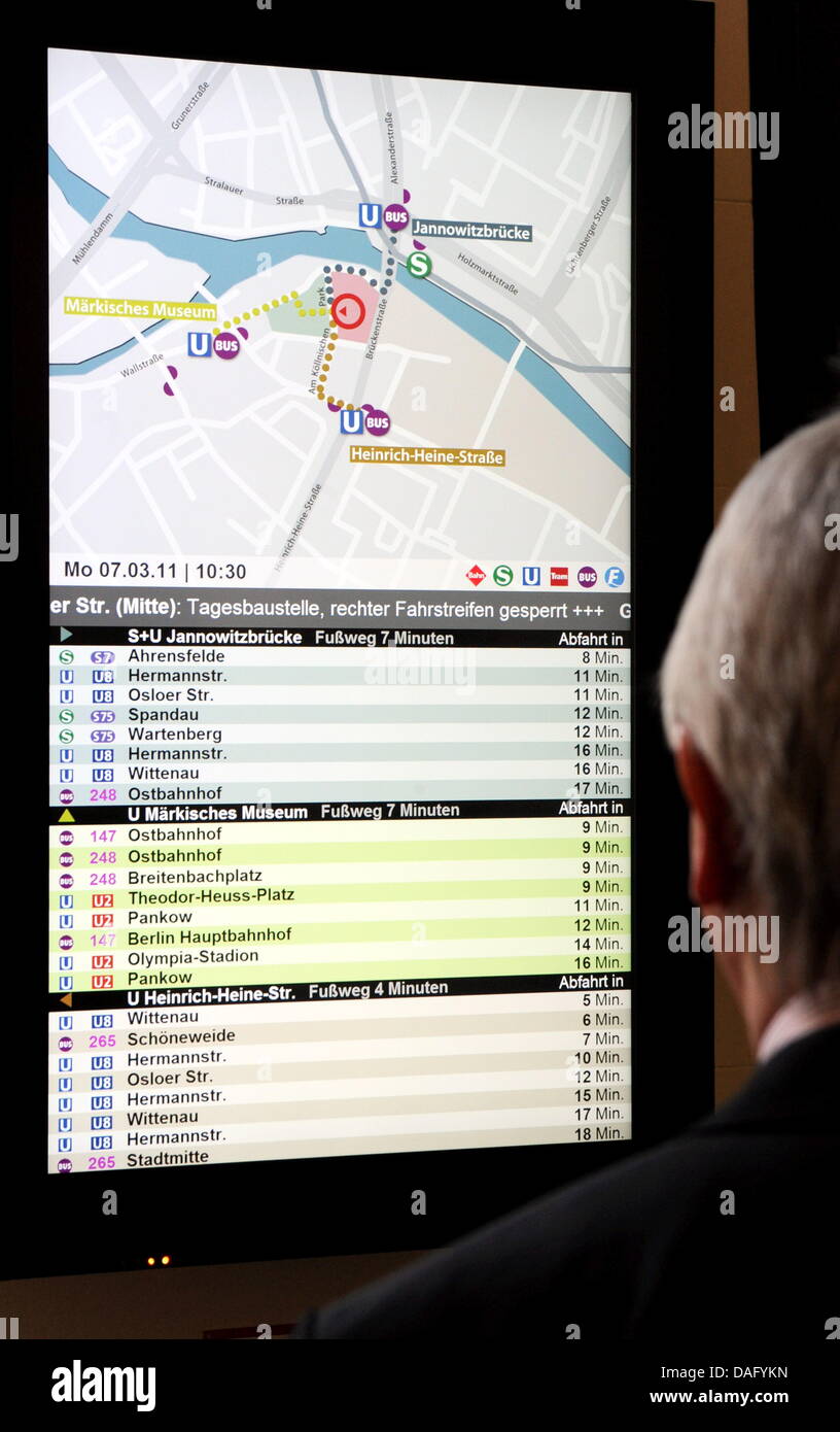 A woman looks on an information monitor of new traffic information ...