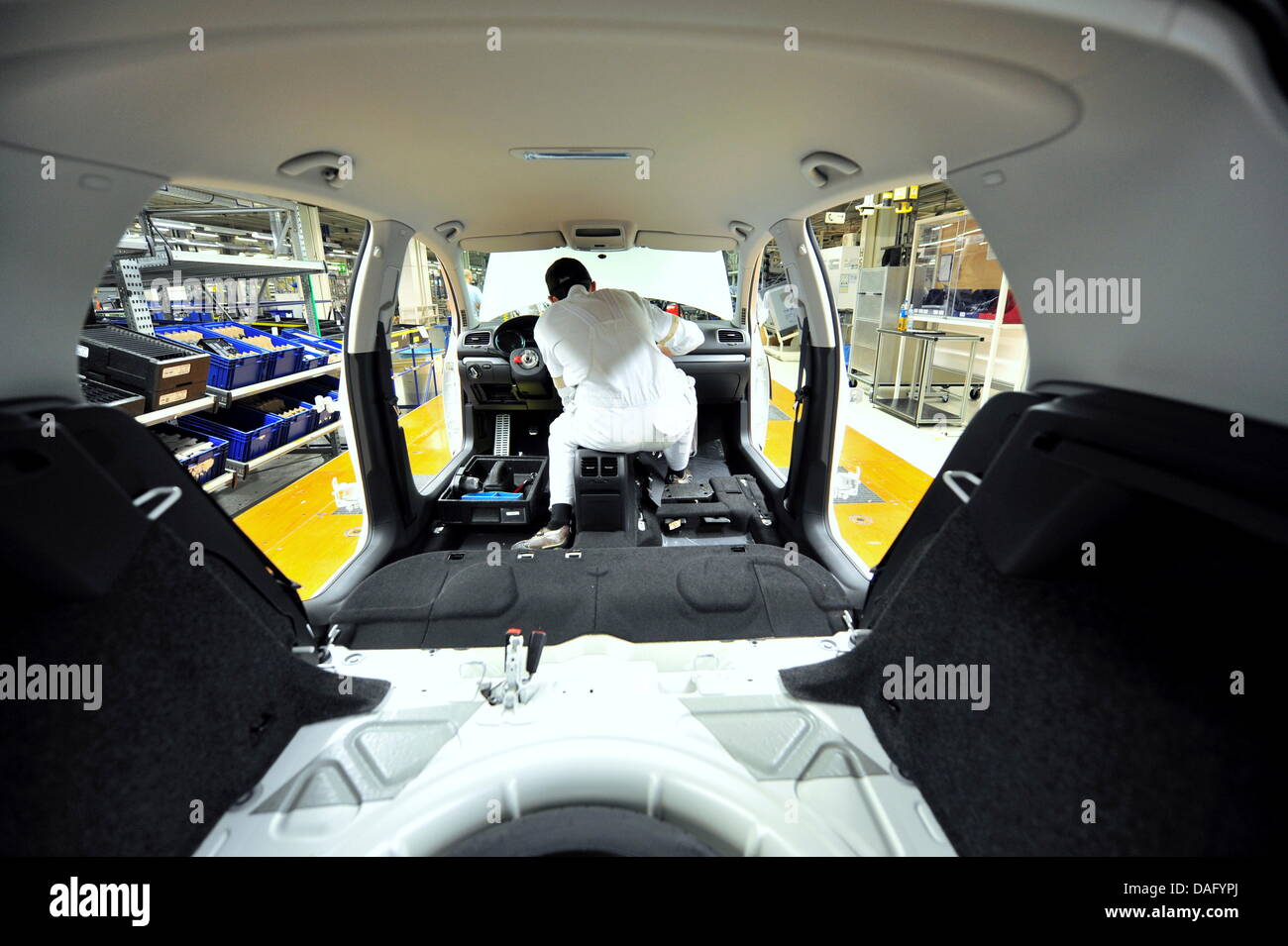 Employees of Volkswagen (VW) assemble a car in Wolfsburg, Germany, 24 ...