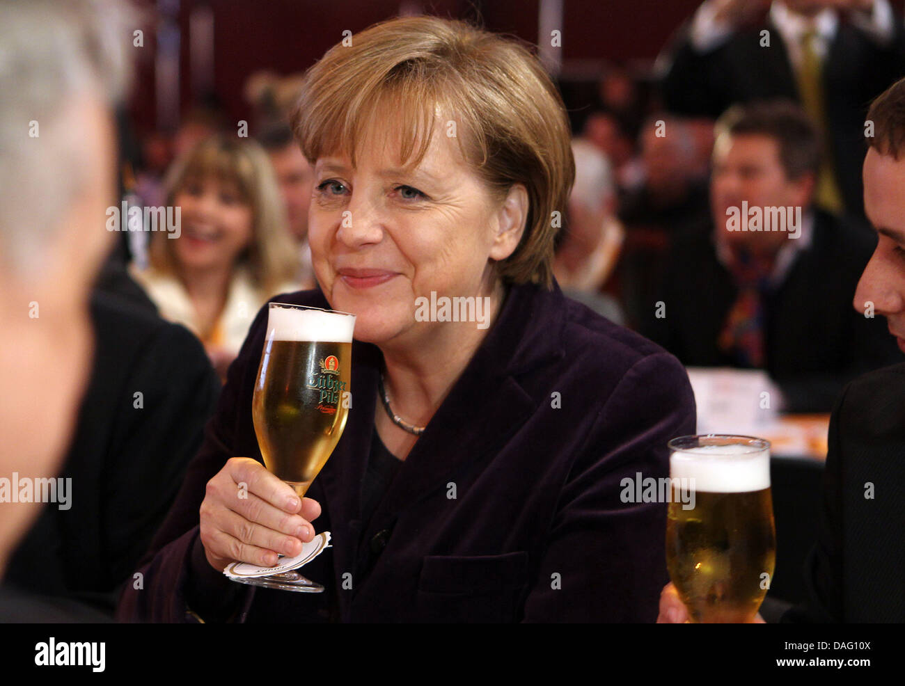 German Chancellor Angela Merkel toasts with a glass of beer at the ...