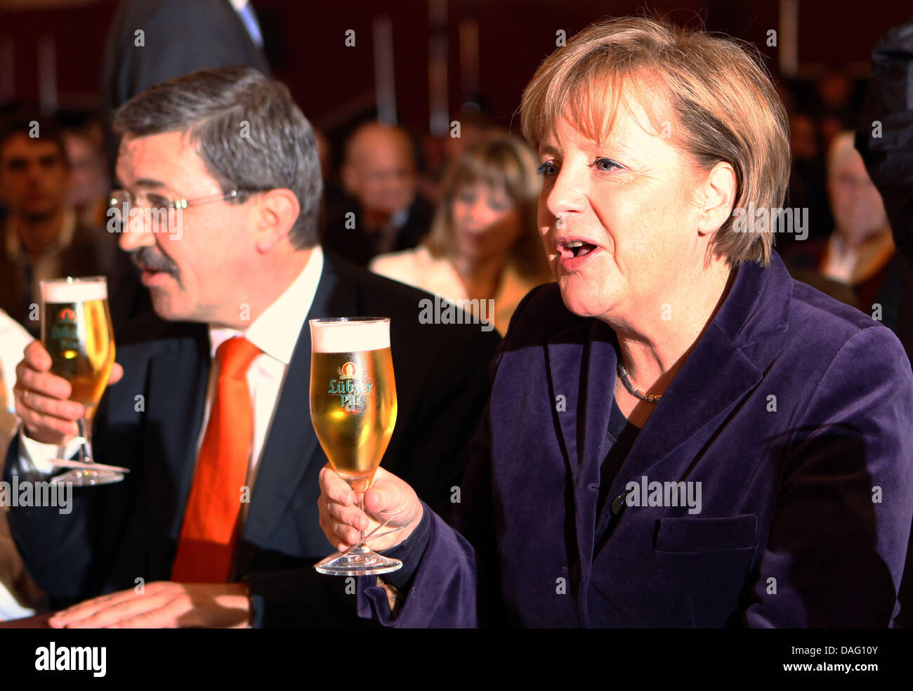 German Chancellor Angela Merkel toasts with a glass of beer at the ...