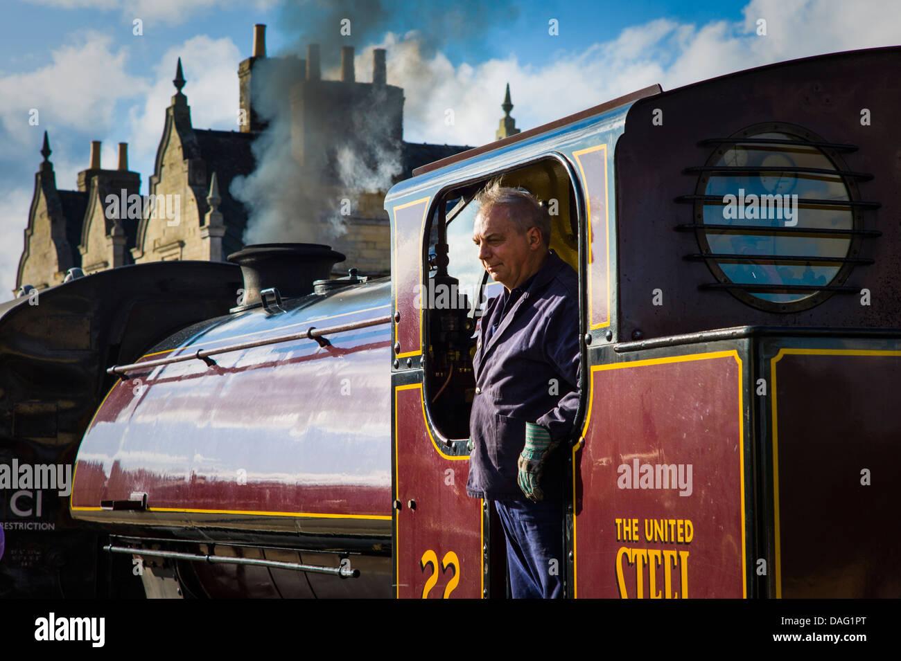 Engine driver of the footplate of a steam engine at Nene Valley Railway ...