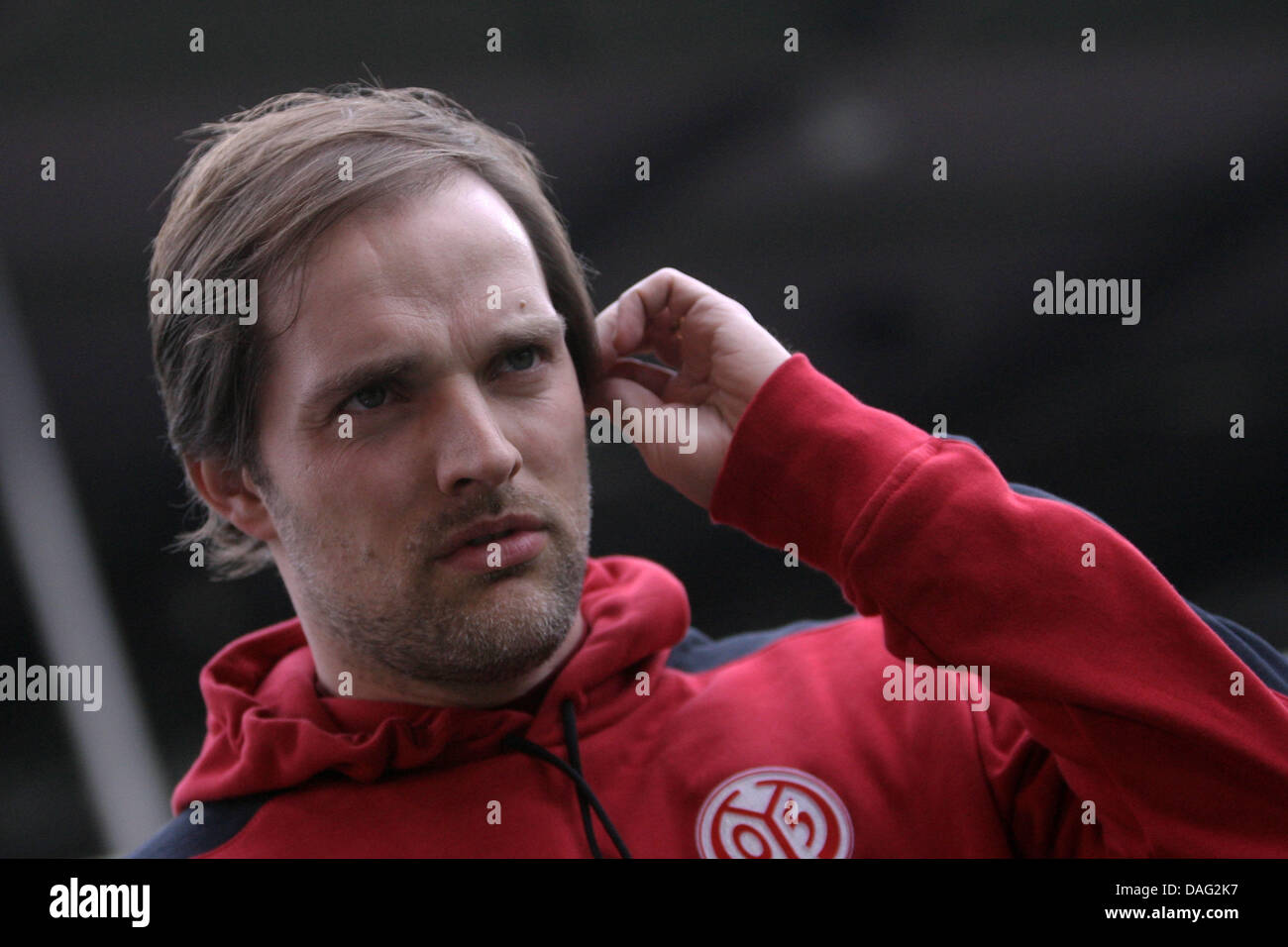 Mainz coach Thomas Tuchel rubs the tip of his ear prior to the start of ...