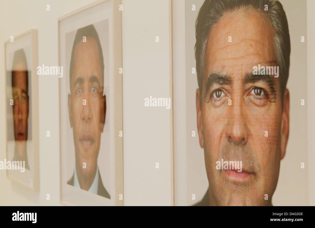 A visitor walks past photographies by photographer Martin Schoeller ...