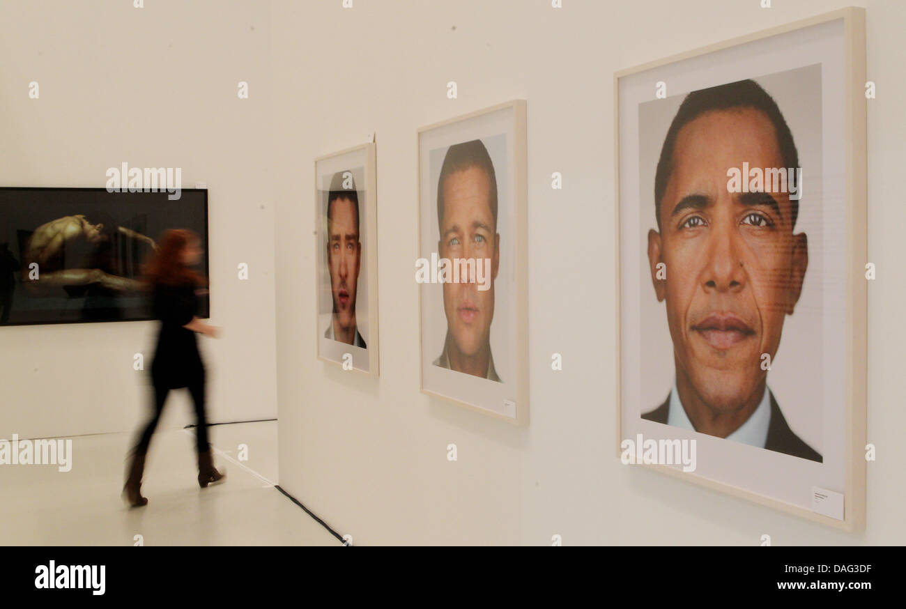 A visitor walks past photographies by photographer Martin Schoeller ...