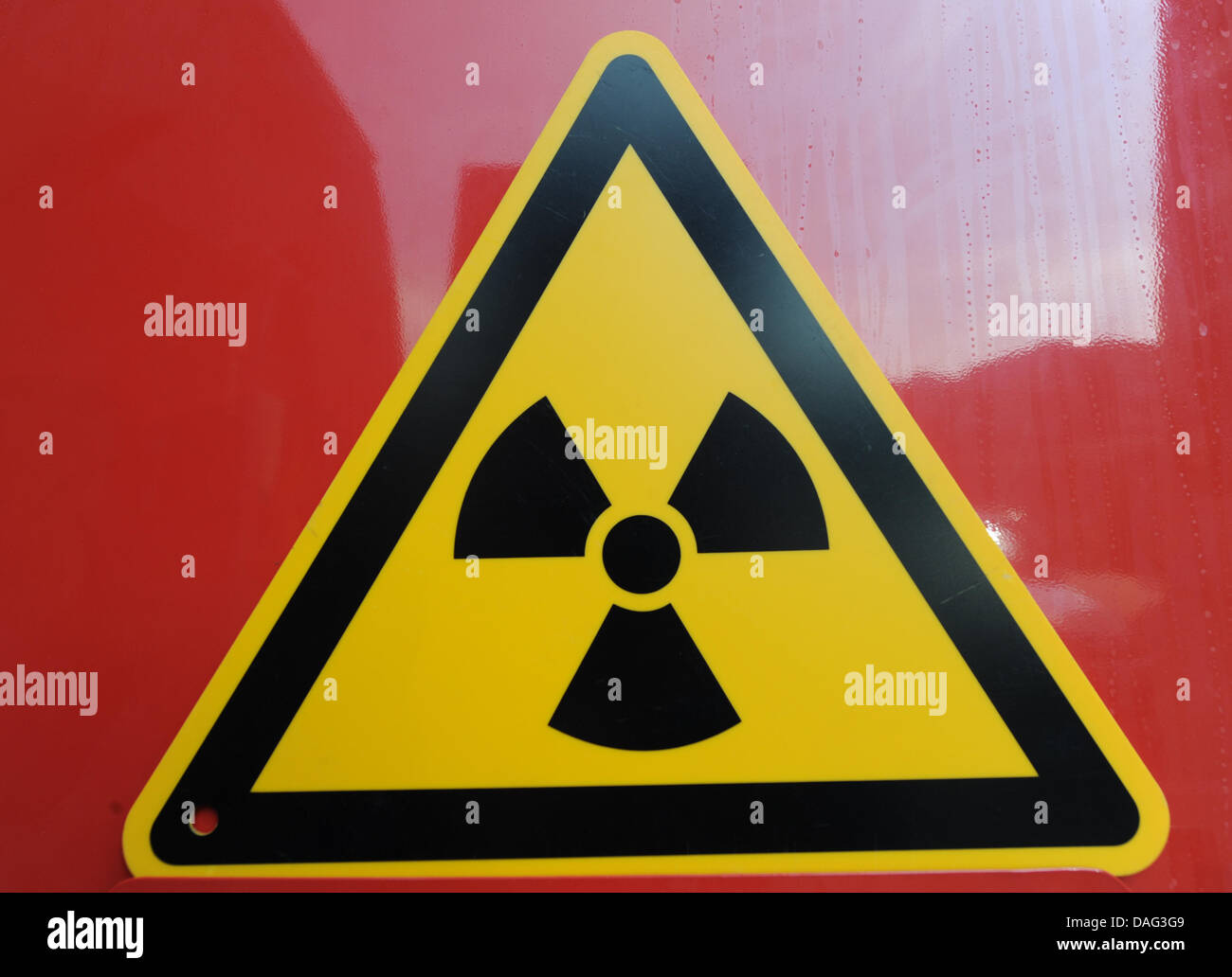 The illustration shows a warning sign indicating radioactivity of the ...