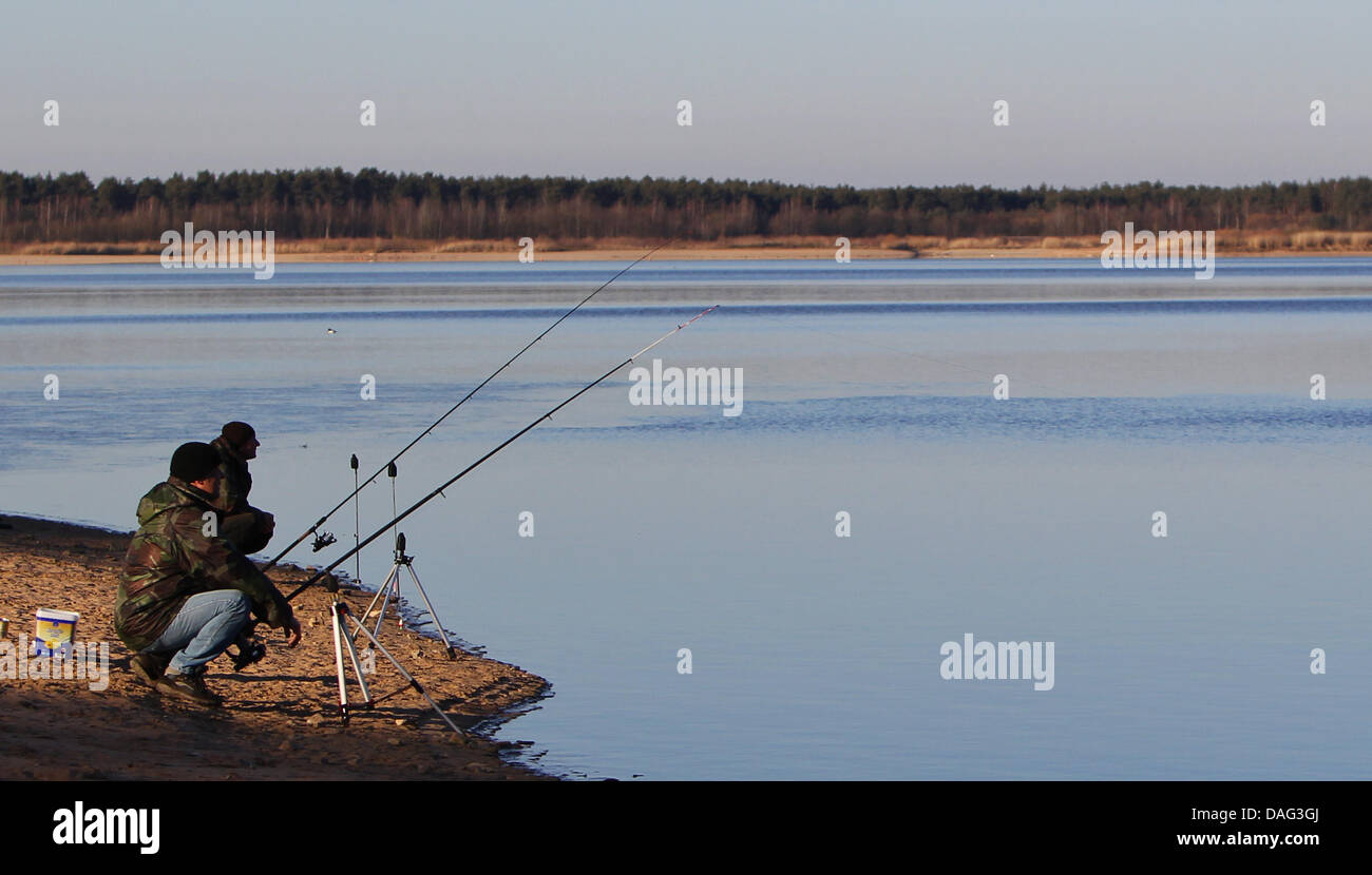 Two men fish from a wooden boat on Rothsee Lake in Birkach, Germany, 8 ...
