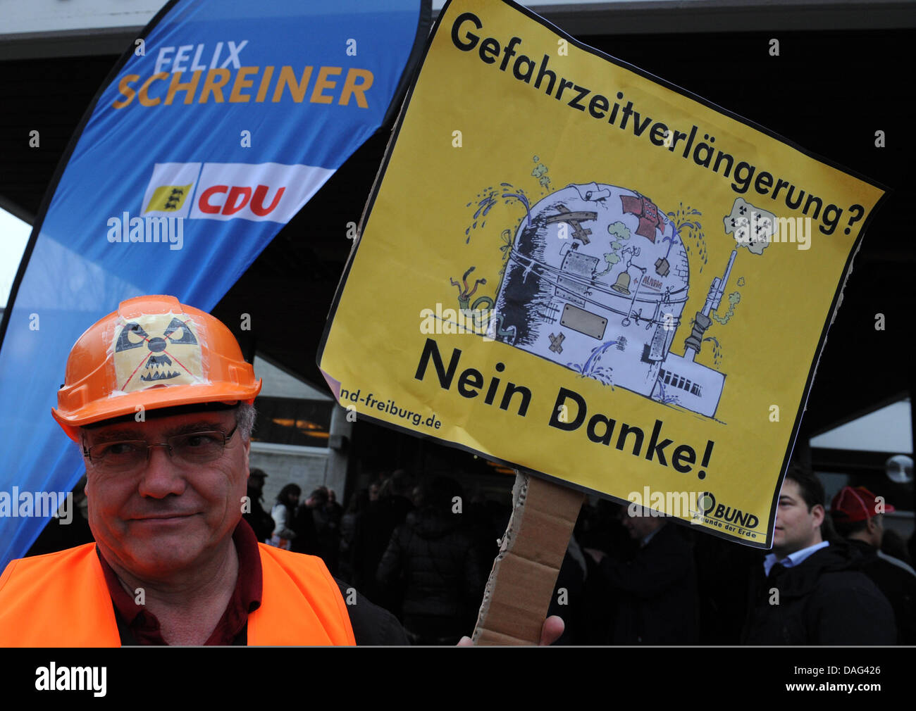 Opponents of nuclear power protest with signs during an election ...