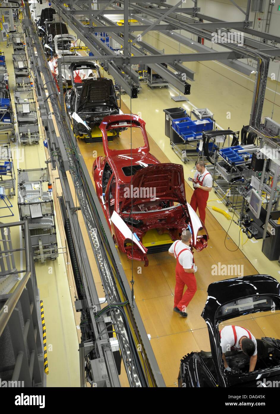 An engineer works on a Porsche Panamera 4S on the assembly line at the ...