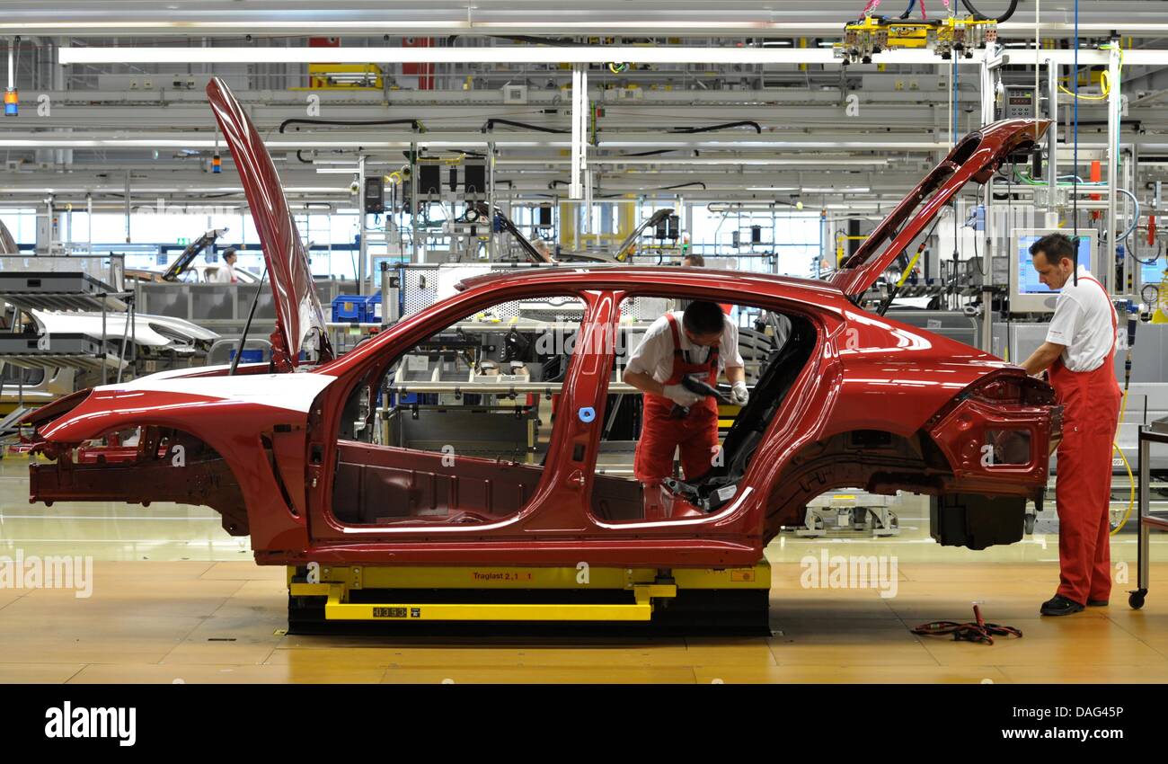 An engineer works on a Porsche Panamera 4S on the assembly line at the ...