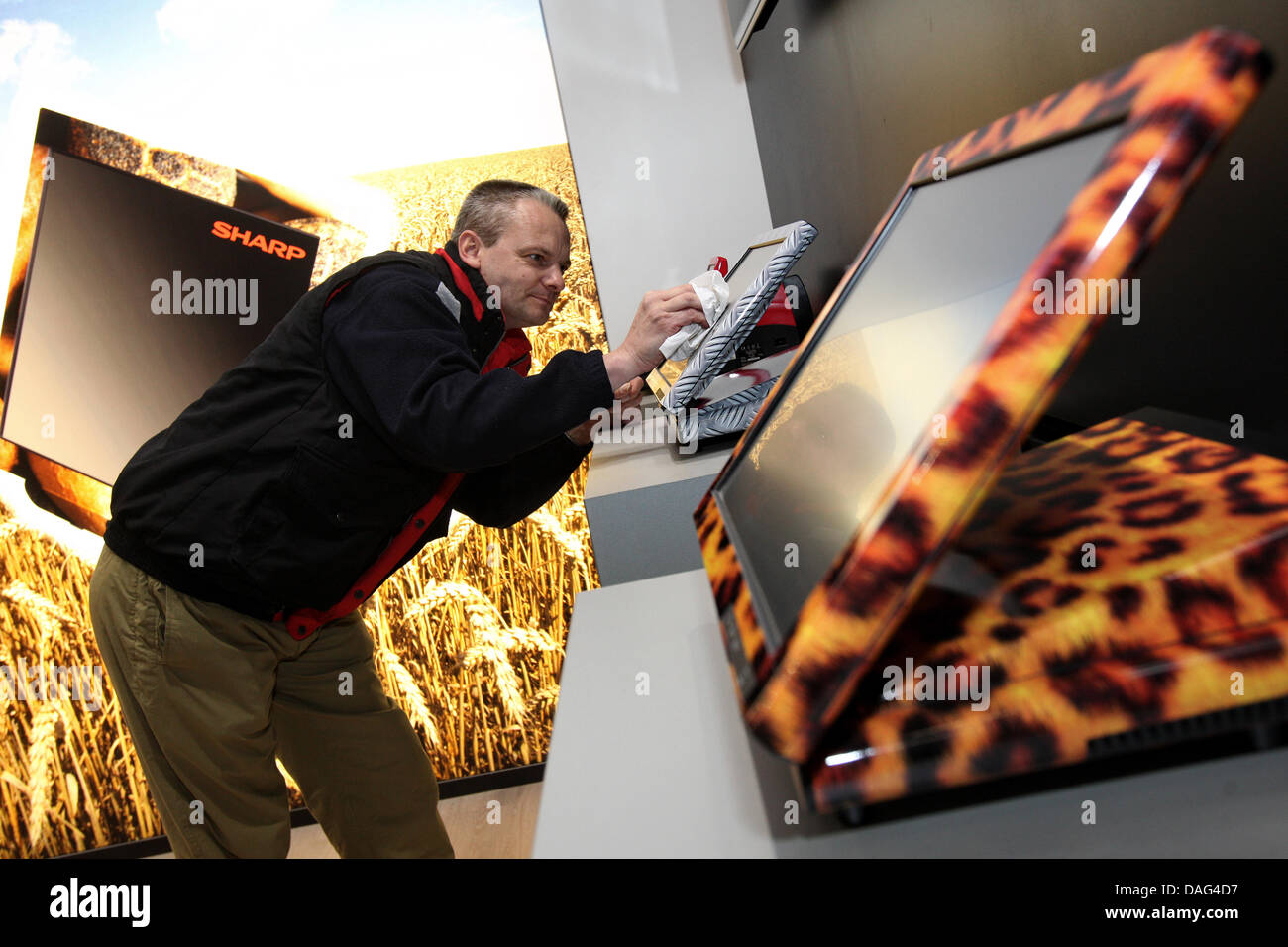 The picture shows an employee working at the Sharp booth at the ...