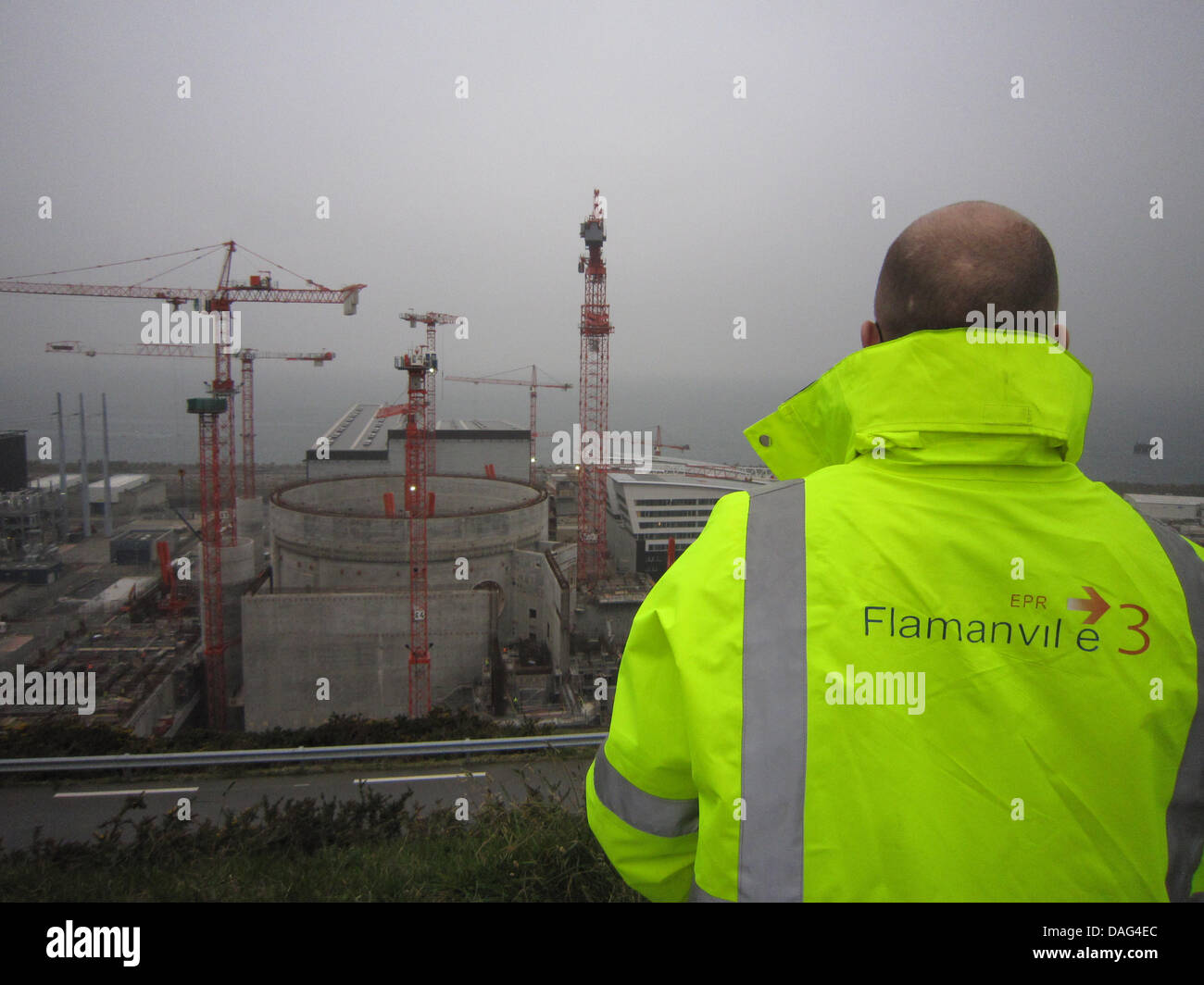 The picture shows an employee of the French power company EDF looking ...
