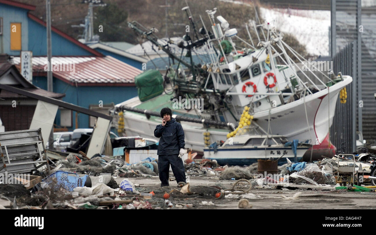 People remove debris from the harbour of Hachinohe, Japan, 18 March ...