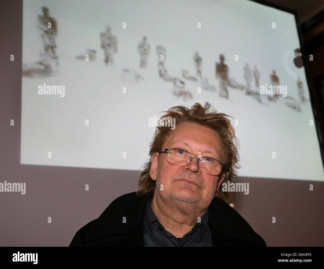Artist HA Schult sits before a screen with a live broadcasting of his ...