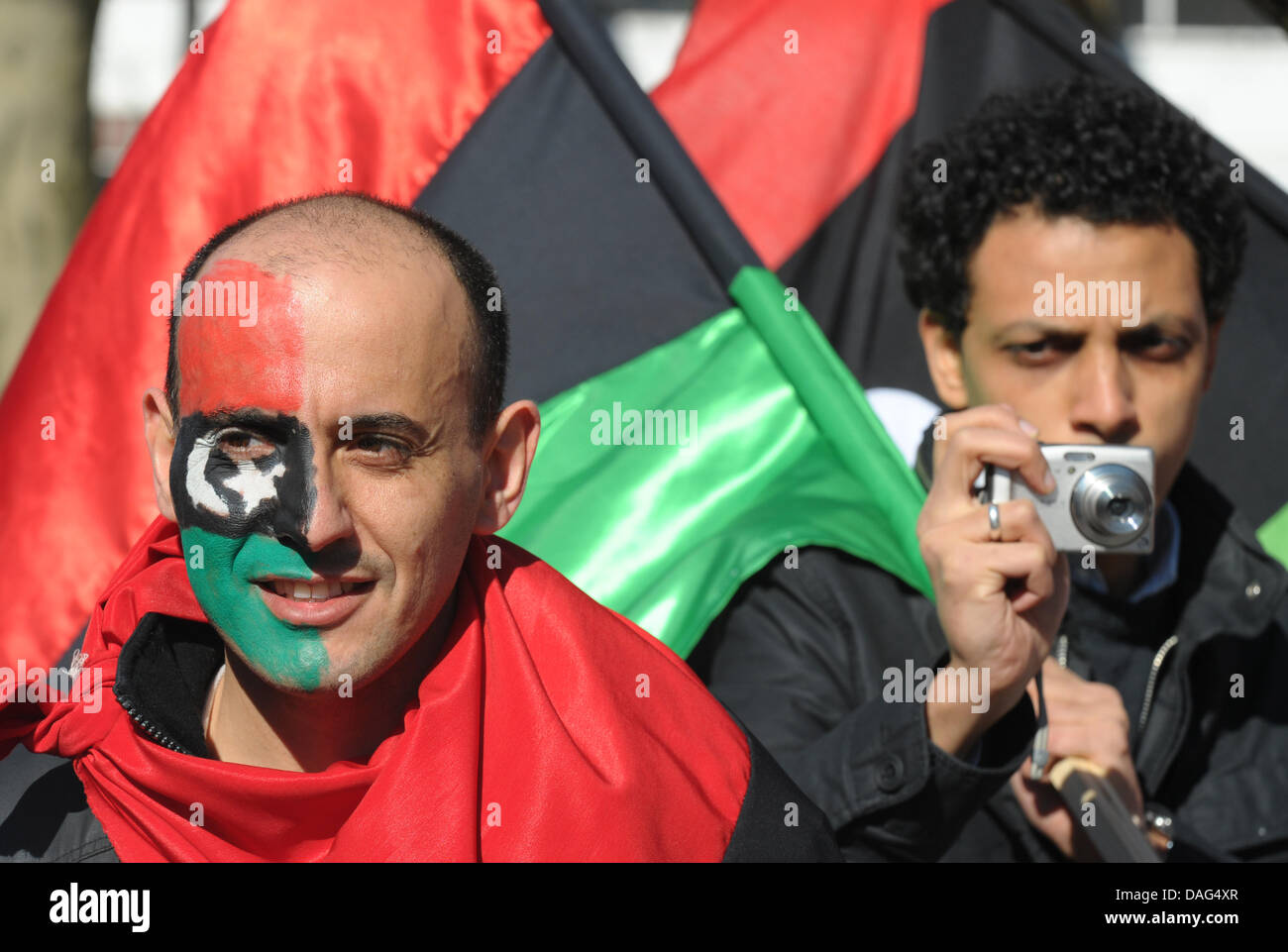 A member of Berlin's Libyan community has painted his face in the ...