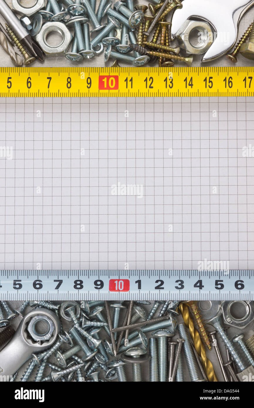 metal construction hardware tool on checked paper Stock Photo - Alamy