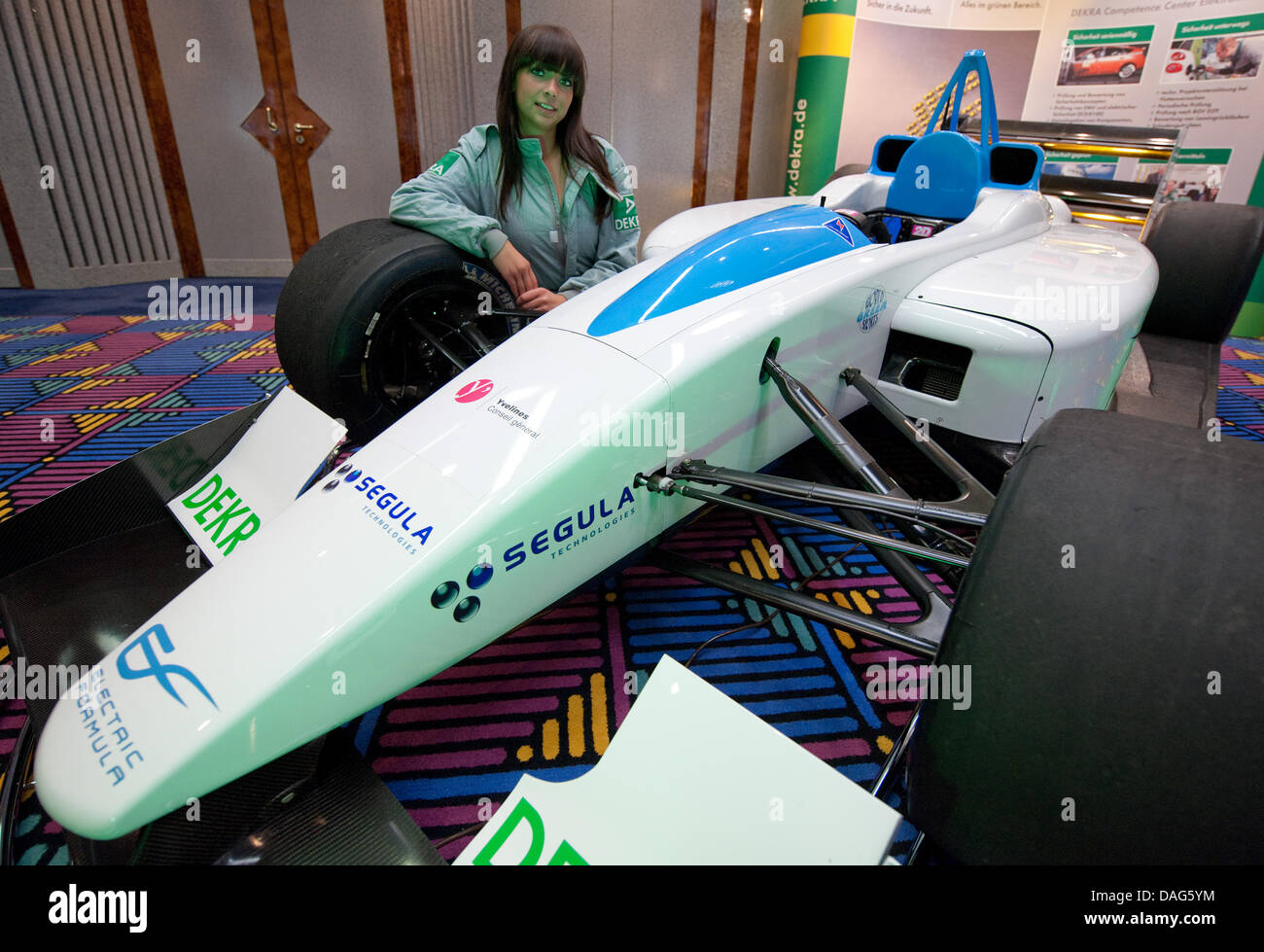 A woman smiles next to electric-powered race car EF01 by Formulec at ...