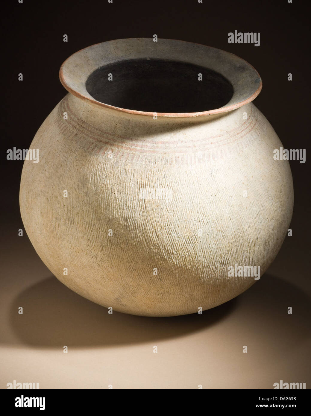 This pottery piece features a slightly flaring rim, highlighting the ...