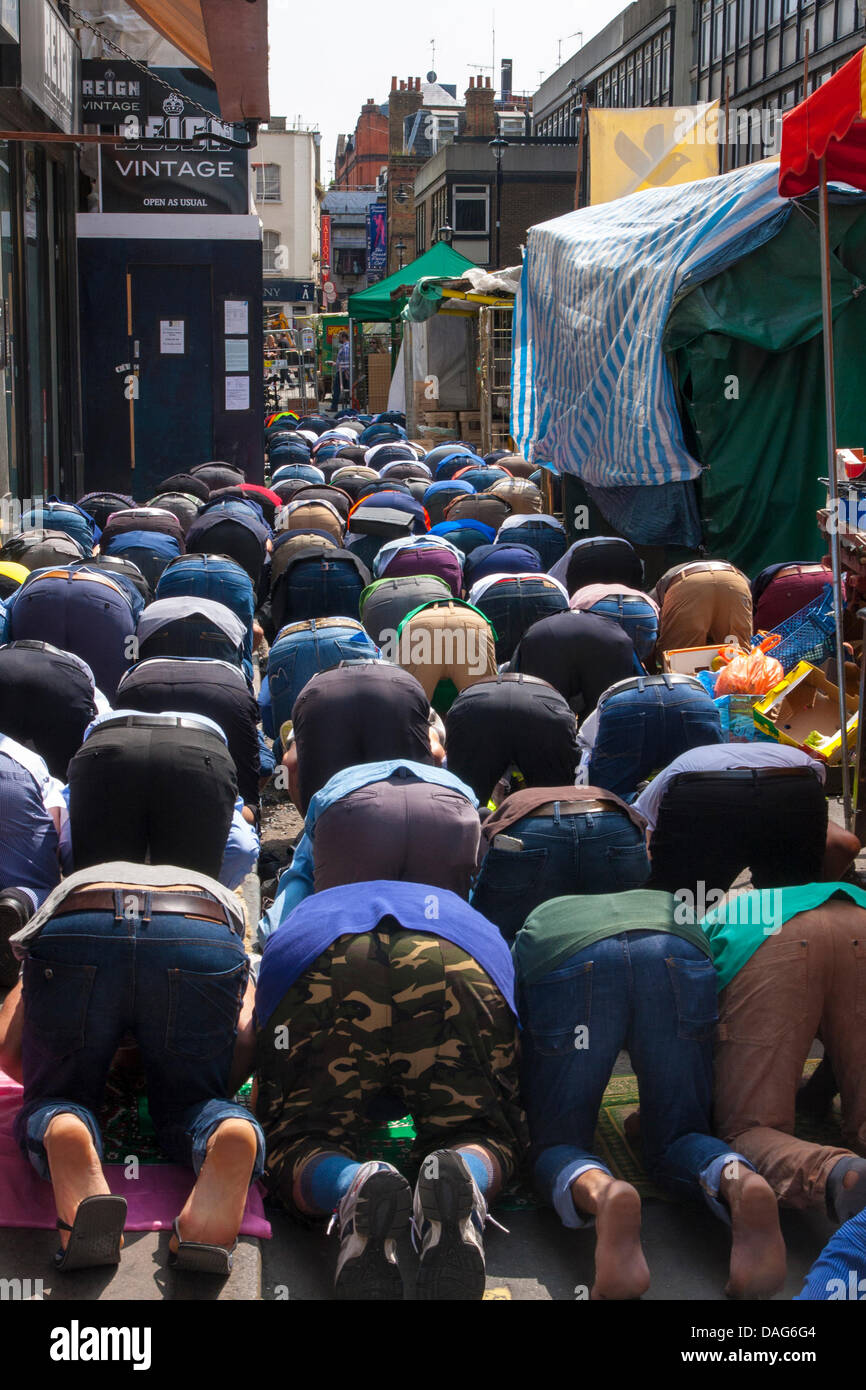 London, UK. 12th July 2013. Muslims pray on Berwick Street in Soho ...