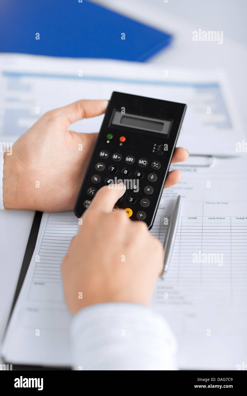 woman hand with calculator and papers Stock Photo - Alamy
