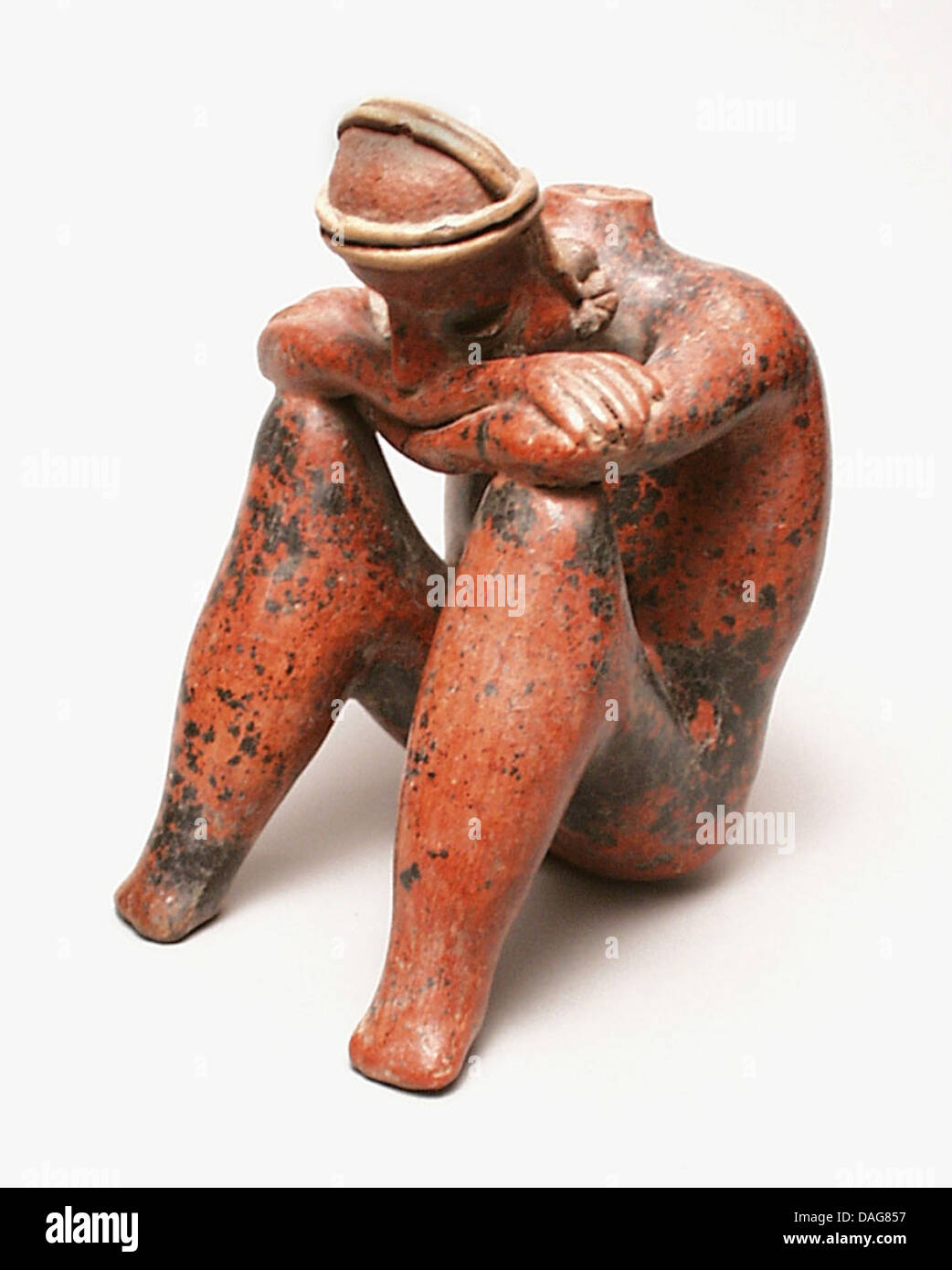 This seated male figure is a sculpture that portrays the human form in ...
