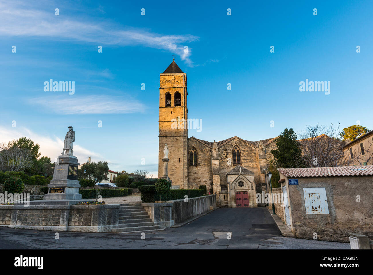 St Laurent Church and war memorial in the village of Roujan, Hérault ...