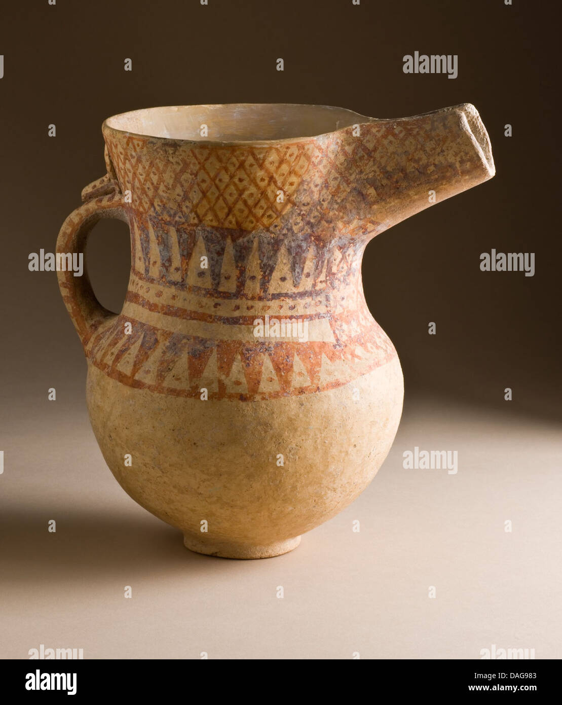 This spouted jug is a fine example of ancient pottery, featuring a ...
