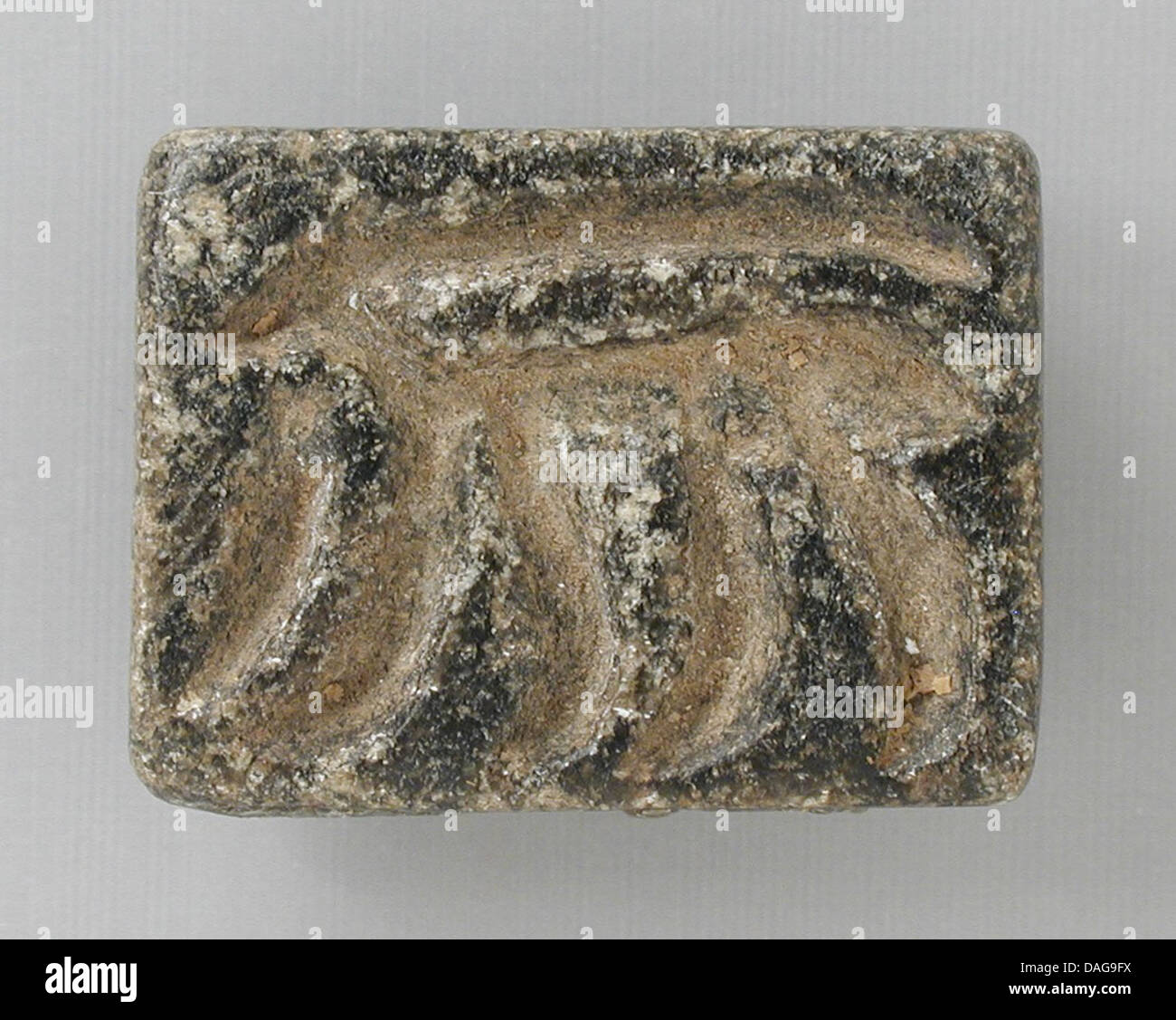 This gabled stamp, with a rounded back, is a tool used in ancient ...