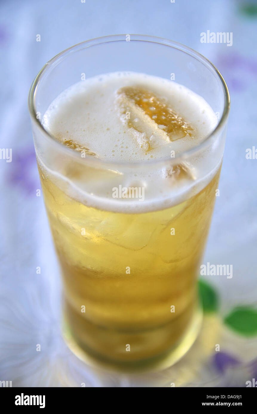 Glass of beer and ice Stock Photo - Alamy