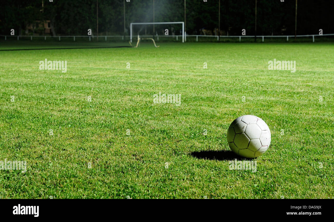 Football pitch at night, with some artificial lightning and a football ...