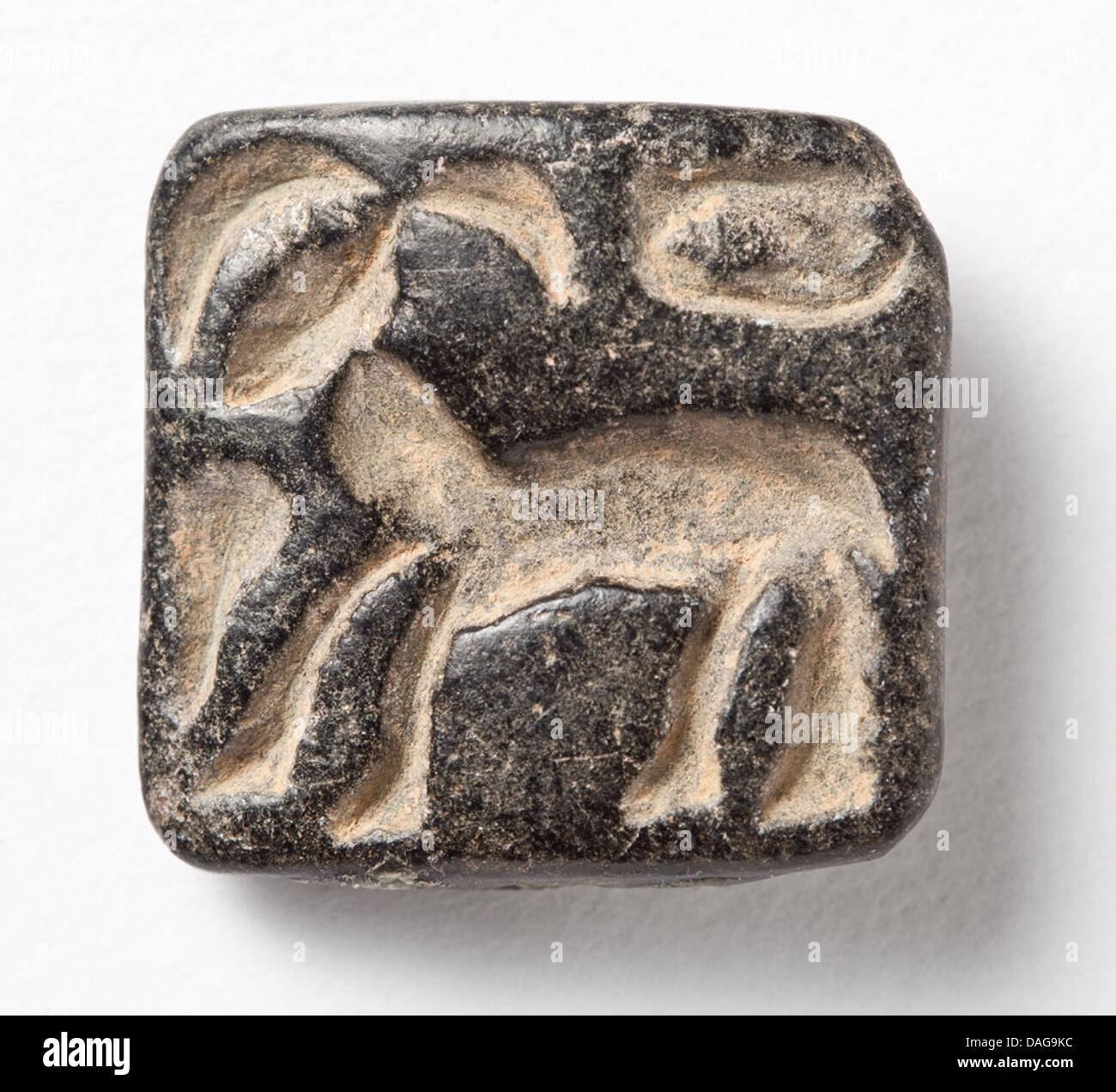 This stamp seal from the ancient world features a gabled design ...