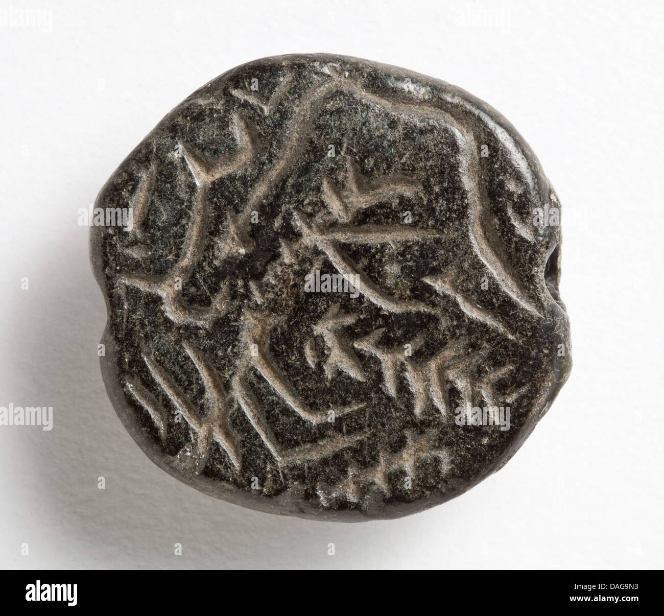 This ancient stamp seal features a gabled design with a rounded apex ...