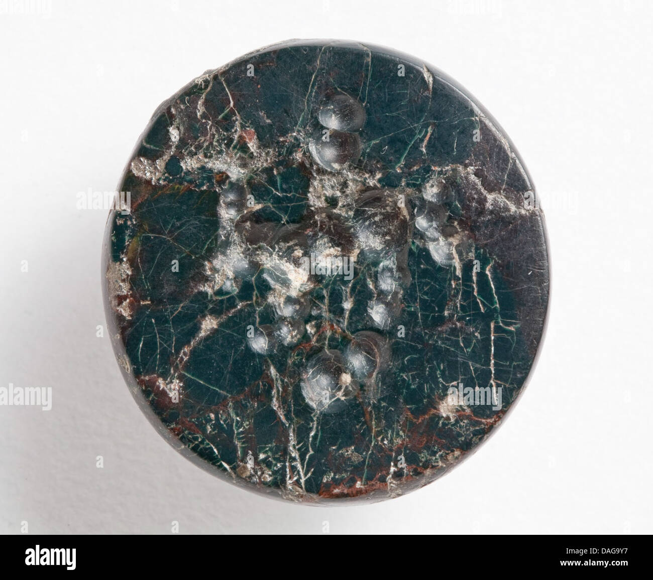This hemispheroid-shaped stamp seal is made of bronze, likely used in ...