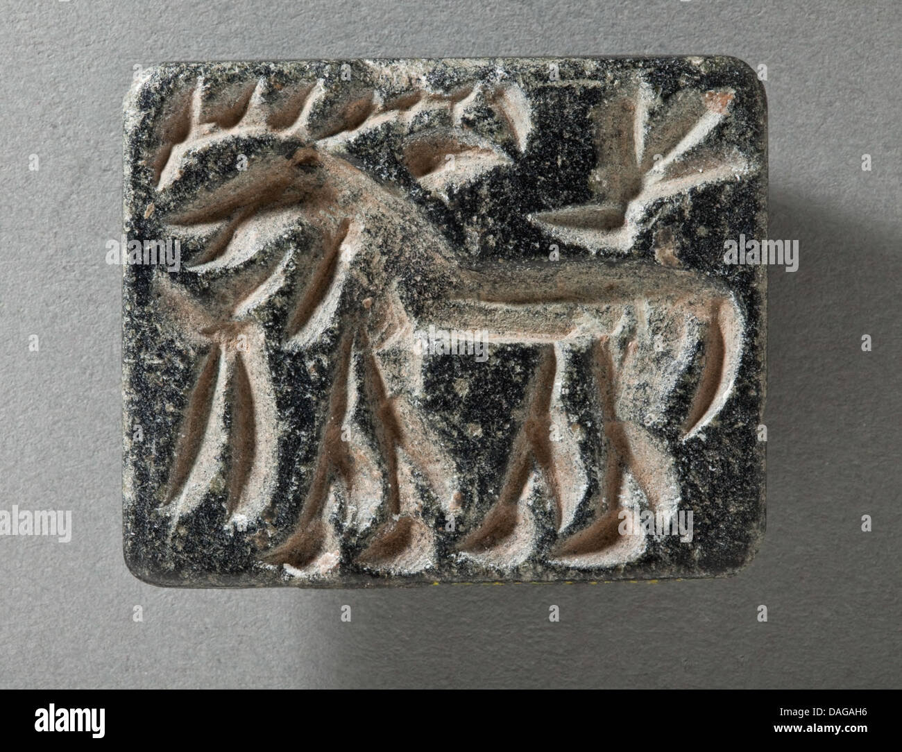 This ancient stamp seal is carved from stone and was used for pressing ...